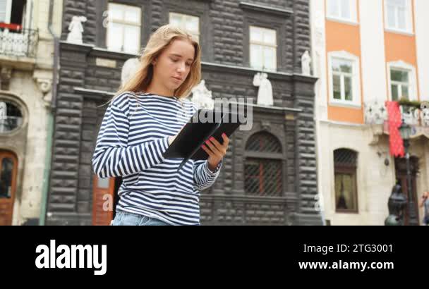 Young female lady using digital tablet to communicate with friends ...