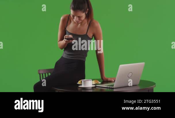 Happy young woman texting messages with smart phone and casually ...