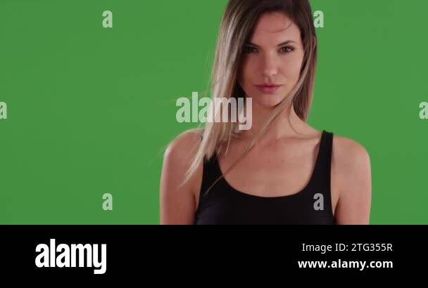 Athletic and fit young millennial woman flexing biceps and kissing her ...