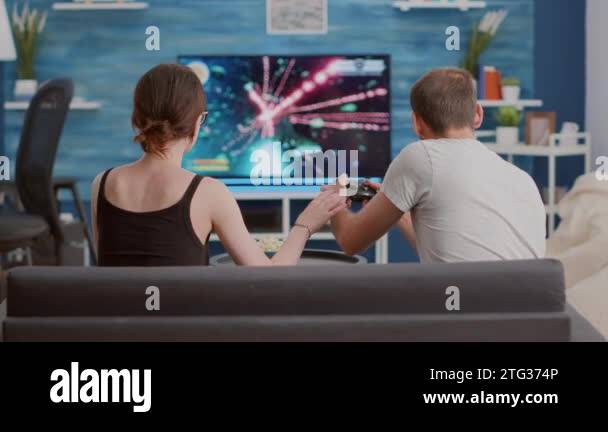 Couple arguing over man losing online game on console in front of big ...