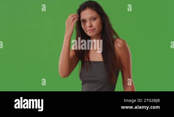 Portrait of pretty caucasian girl posing indoors green screen studio ...
