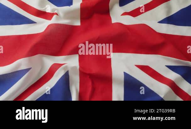 Video of creased flag of great britain lying on white background ...