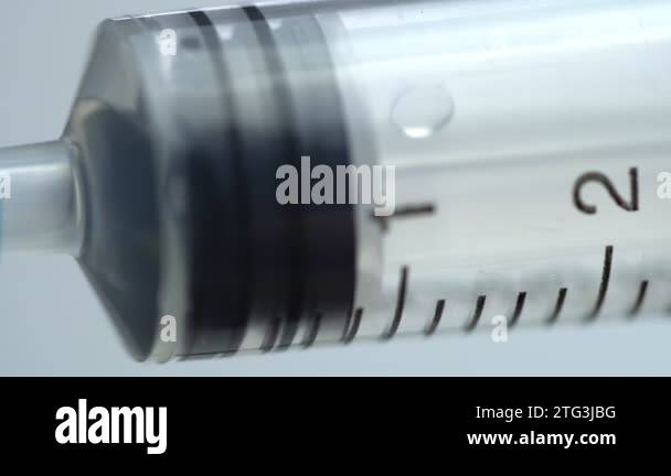 Extreme close-up of filling syringe with liquid medication. 4k Stock ...