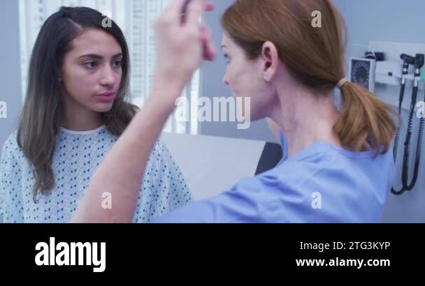 Portrait of senior nurse talking with young latina patient about health ...