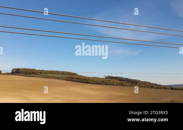 High voltage tower with electric power lines divided by safe guard ...