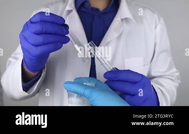 Medical laboratory assistant checks a test tube with sperm. Spermogram ...