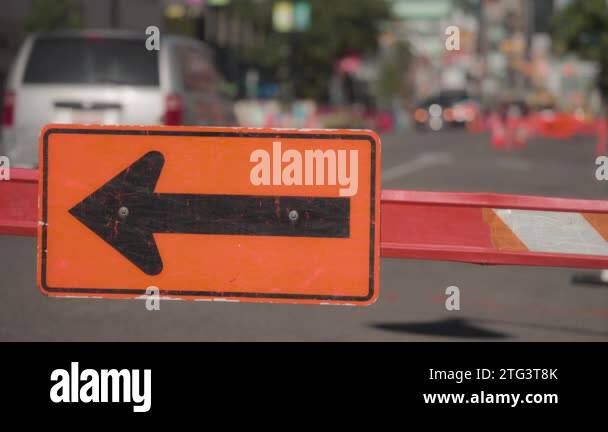 Left direction traffic sign due to construction Stock Video Footage - Alamy