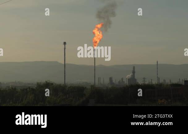 Burning a torch at a chemical plant. Emission of harmful substances ...