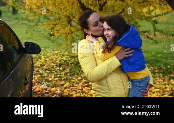 Happy multi-ethnic family of a loving single mother in yellow jacket ...