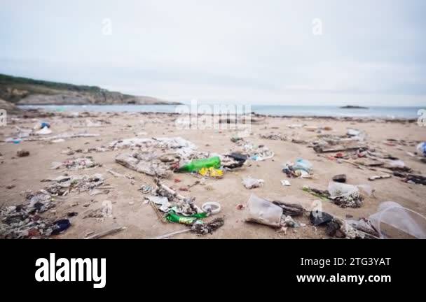 Plastic pollution of the sea shore. Polluted beach with plastic waste ...