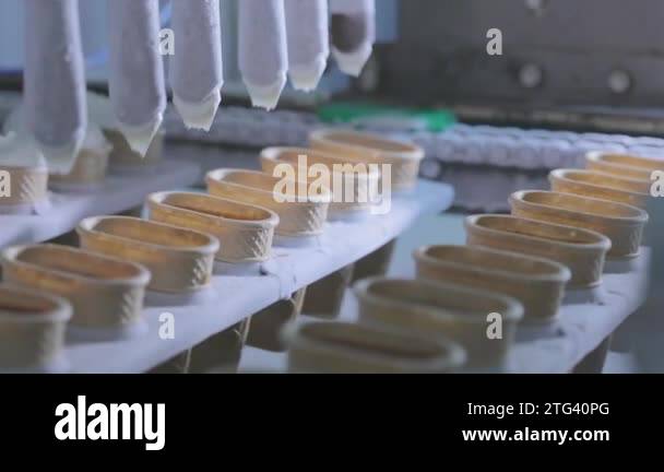 Ice cream is poured into a faffle cup. Ice cream production. Ice Cream ...