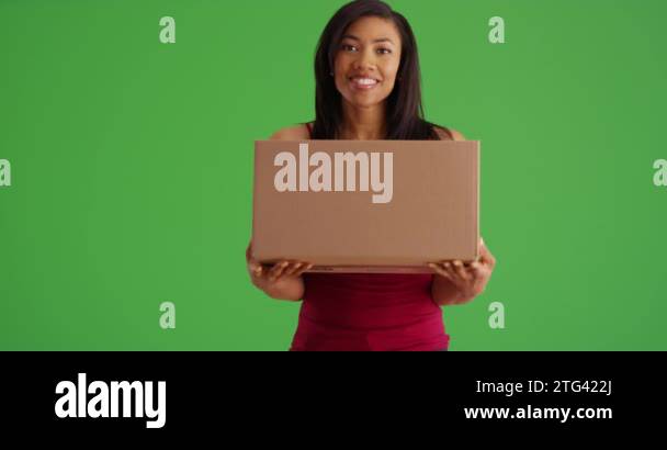 Happy smiling Black woman holding cardboard box shipment she received ...