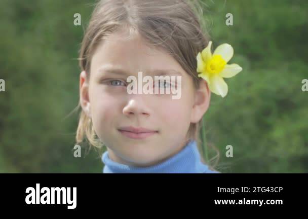 Portrait of a boy in the spring with a flower of yellow narcissus ...