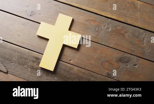 Video of yellow christian cross crucifix symbol on old wooden ...