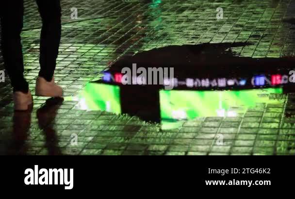 Body parts of walking people on the street in Shinjuku at night rainy ...