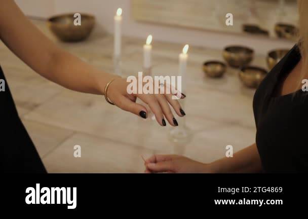 Female hands tie a red thread around the womans wrist as a blessing for ...