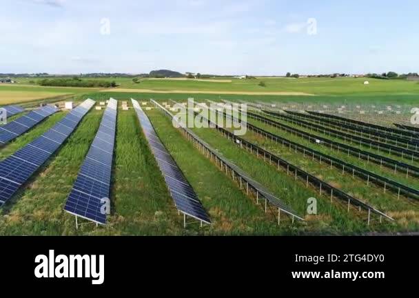 Building Solar Farm. Solar energy panels, aerial view of photovoltaic and wind turbines. Solar ...