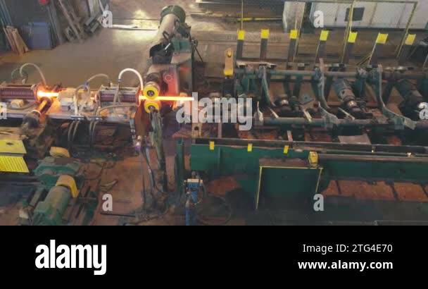 Hot steel pipe production line. Red hot metal pipe production process ...
