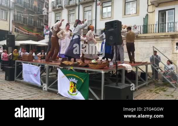Portuguese people dancing on a stage with traditional costumes in the ...