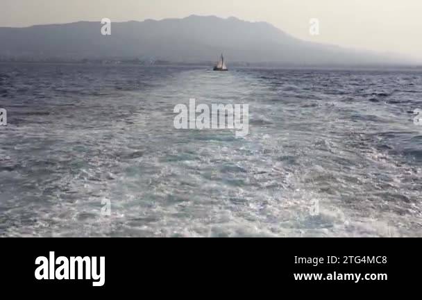 Blue ocean sea water wave with fast yacht boat wake foam of prop wash ...