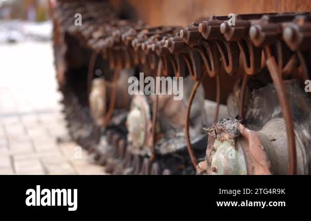 Close-up rusty wheels and tank caterpillar track on city street in Kyiv ...