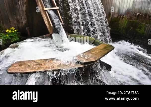 Traditional mechanism for washing clothes under running water in a ...