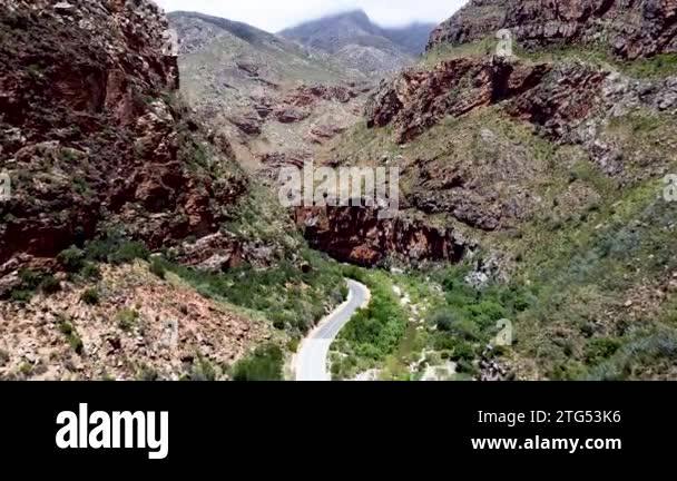 Epic aerial shot travelling through the scenic mountainous landscape ...