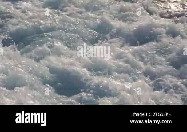 Blue ocean sea water wave with fast yacht boat wake foam of prop wash ...