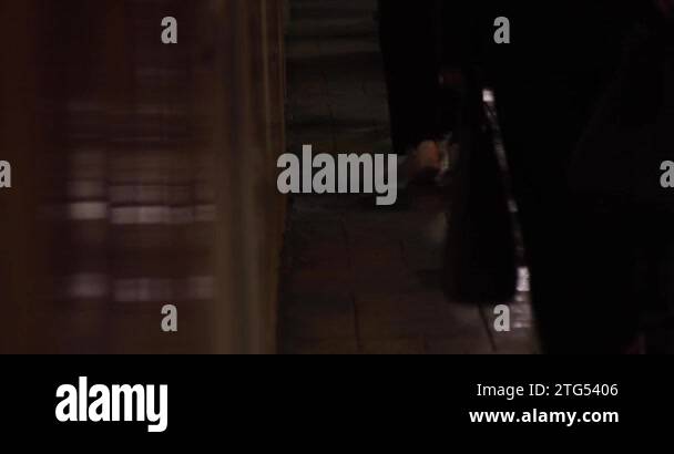 Body parts of walking people on the street in Shinjuku at night rainy ...