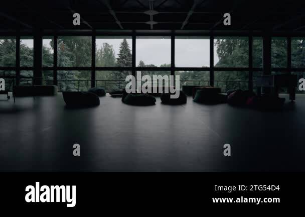 Modern empty dark hall interior with bag chairs sofa at panorama window ...