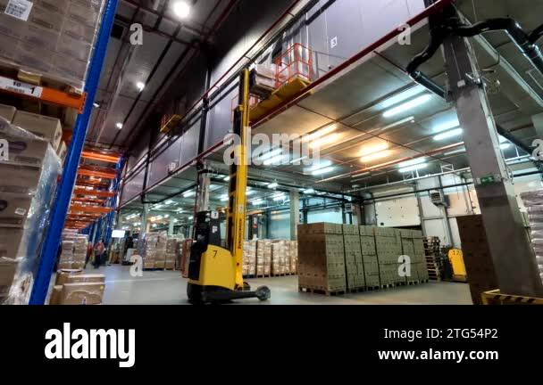 Two level warehouse. The forklift picks up a pallet from the second ...