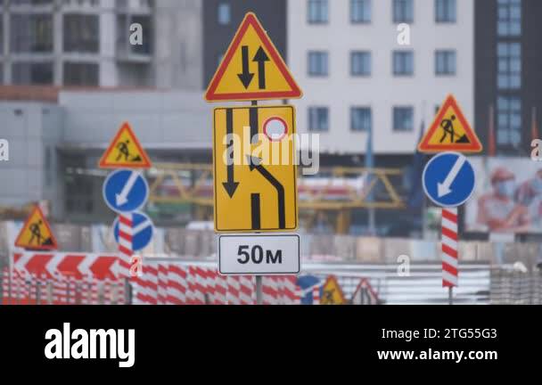 Roadworks warning traffic signs of construction work on city street and ...