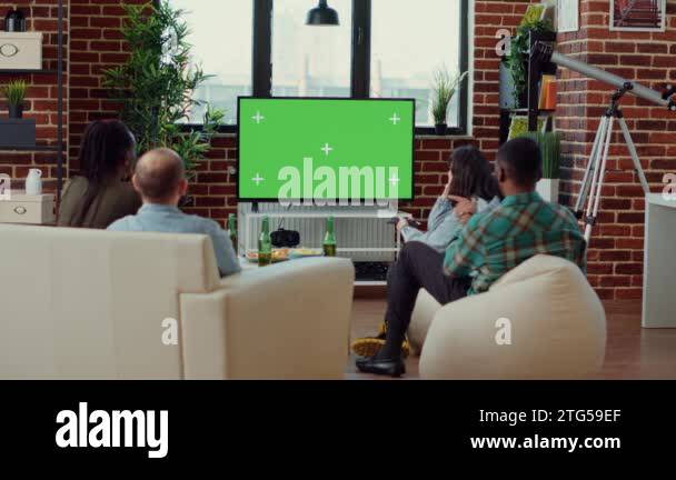 Diverse people switching tv channels on greenscreen template, watching ...