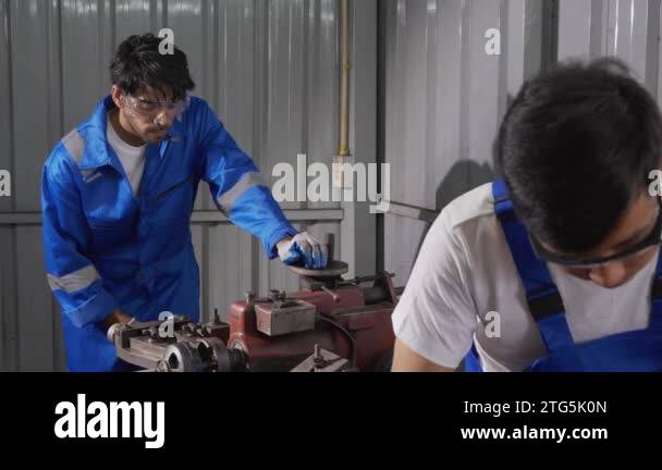 Two young man sanding or iron and break at industrial factory, mechanic ...