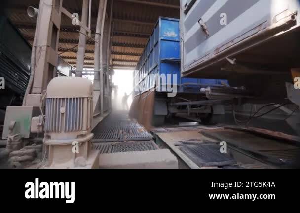 Grain lorry unloading on elevating hydraulic platform unloader at grain ...