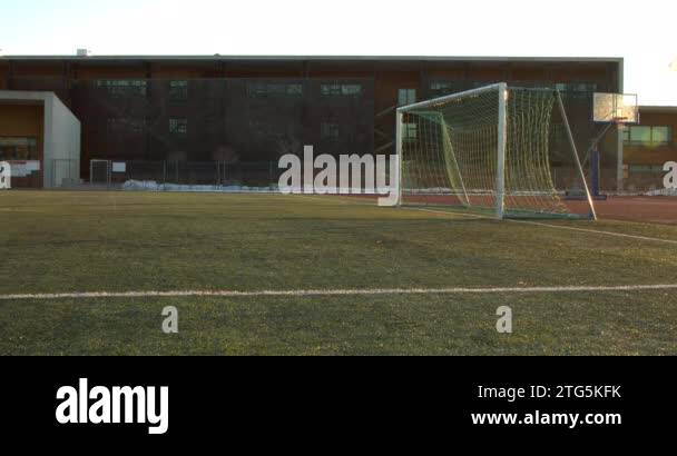 Football goal with sunrise light background in the public stadium. An ...