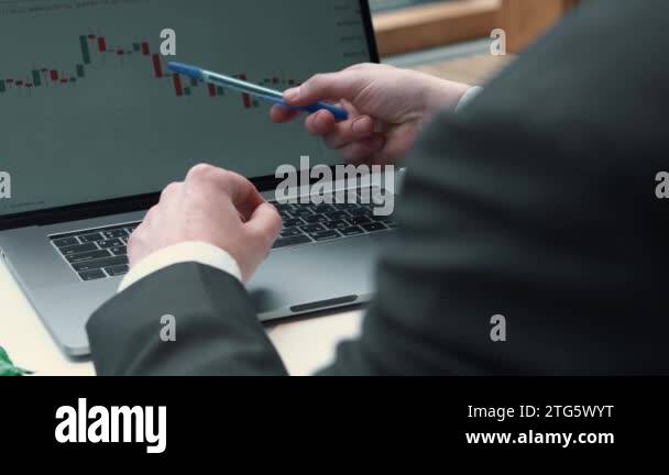 Businessman over the shoulder view with device, scrolling looking at ...