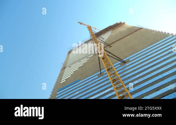 crane tower is attached to frame of building. Construction of ...