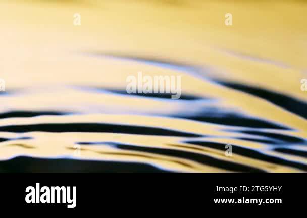 Water surface yellow and blue texture with clean ripples and wave ...
