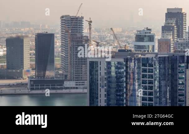 Business Bay Dubai skyscrapers with water canal aerial timelapse. Mixed ...