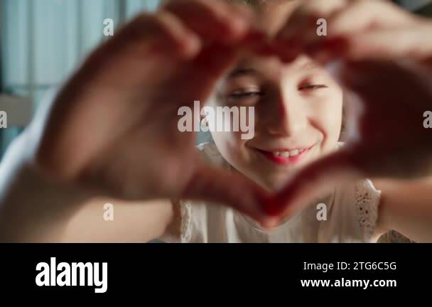 Beautiful happy little cute child daughter face seen through joined ...