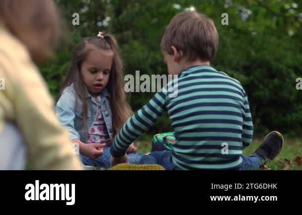 Friends selfie. Excited young children playing lying on grass meadow ...