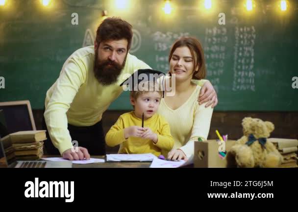 Young family studying. Family playing at home. Parents helping children ...