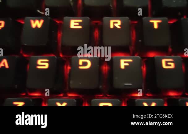 Backlit keyboard close up. Black keys with illuminated characters ...