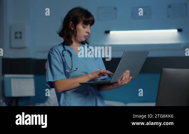 Practitioner nurse holding laptop computer analyzing patient illness ...