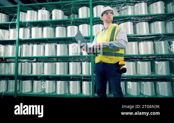 Male worker is doing inventory of fiberglass in the storage. 4K Stock ...