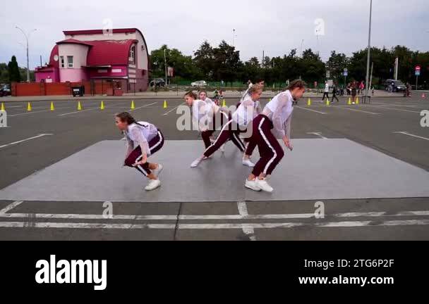 Young girls dancers dance in a public place. Street dancers show a ...