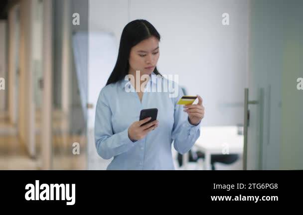 Mobile banking concept. Young serious asian woman manager making online ...