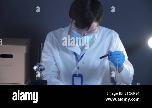 Health care worker with blood test tubes in clinical laboratory ...