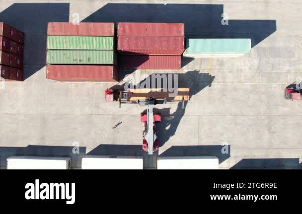 Container Handler Loading a Truck in Port Terminal. Transportation of ...